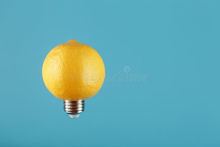 Light Bulb Lemon in Flight on a Blue Background. the Conceptual Idea ...