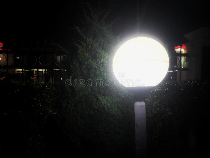 A Light Bulb Lights Up at Night in a City Park Stock Photo - Image of ...