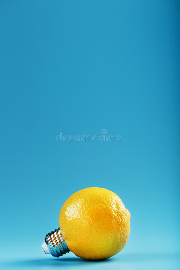 The Light Bulb Is Like A Lemon On A Blue Background Stock Photo - Image ...