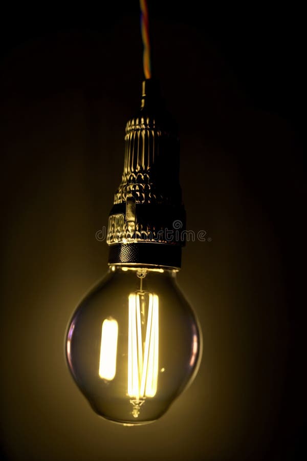 A Light Bulb that is Lit Up in the Dark. Generative AI Stock ...