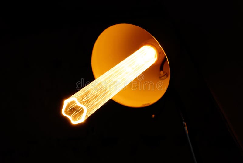A Light Bulb is Lit Up and is Glowing Yellow Stock Image - Image of ...