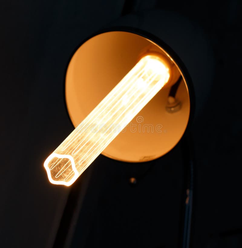A Light Bulb is Lit Up and Has a Long, Thin Shape Stock Image - Image ...