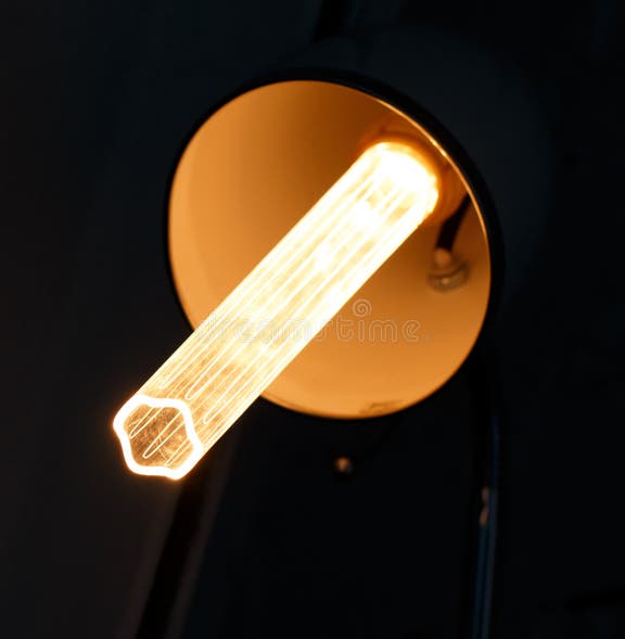 A Light Bulb is Lit Up and Has a Long, Thin Shape Stock Image - Image ...