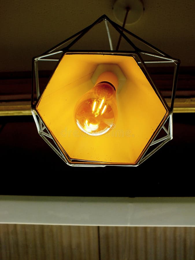Light Bulb is Lit Up in a Hexagonal Shaped Lamp. Stock Image - Image of ...