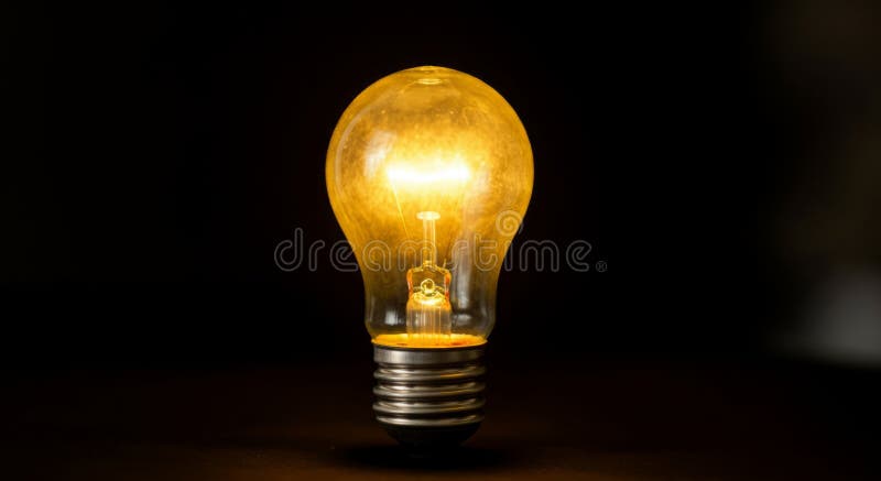 Light Bulb is Lit Up and is Sitting on a Table Stock Photo - Image of ...