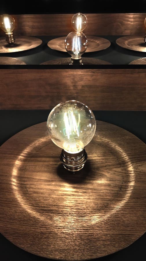A Light Bulb is Lit Up in a Wooden Plate Stock Image - Image of design ...