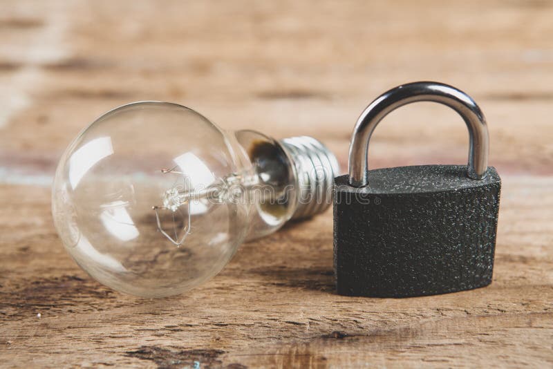 Light Bulb and Lock on Wooden Table Stock Photo - Image of smart ...