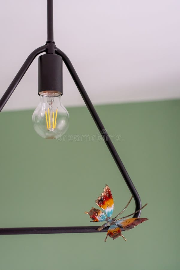Light Bulb with a Metal Butterfly. Loft Style Stock Image - Image of ...