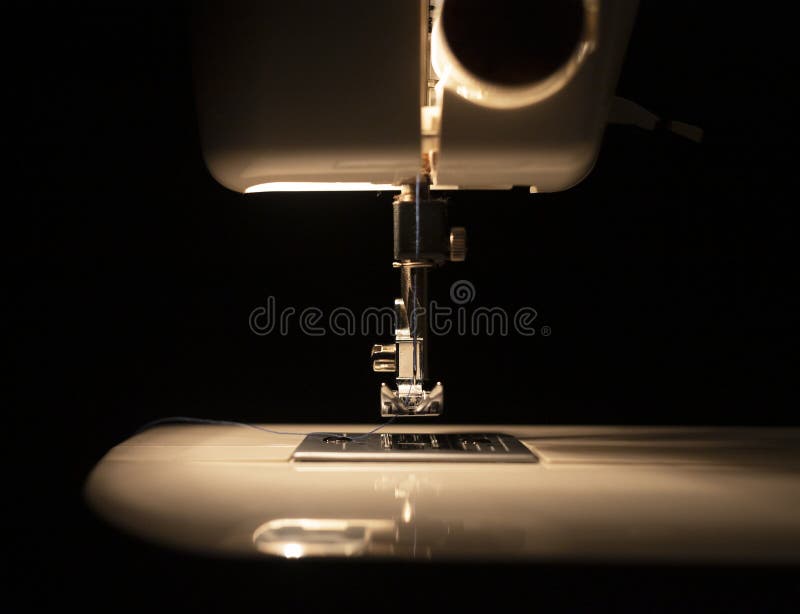 Light from Bulb of Modern Sewing Machine in Darkness Stock Photo ...