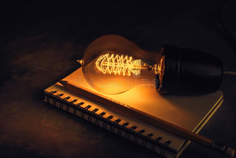 Light Bulb on a Notebook with Pencil, Inspiration and Education Stock ...