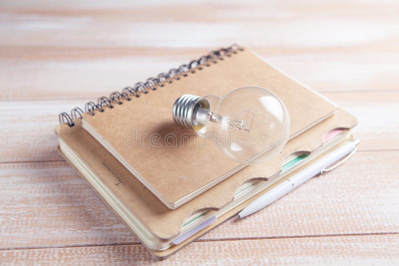 Light Bulb on Notepad. Concept of Ideas Stock Photo - Image of success ...