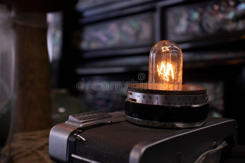 Light Bulb on an Old Camera Lens. Stock Image - Image of technical ...
