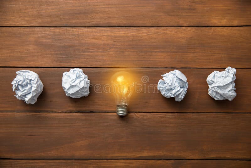 Paper with bulb on board stock image. Image of piece - 196973997