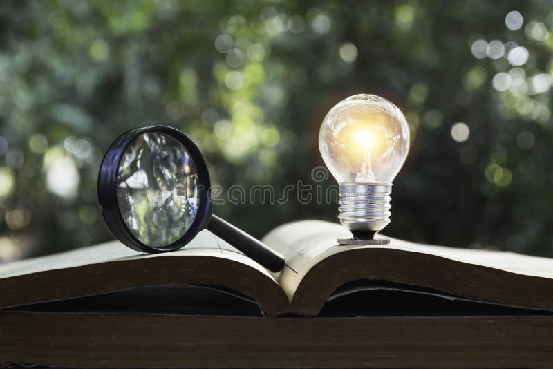 Light Bulb and Pile of Book on Table and Copy Space for Insert Text ...