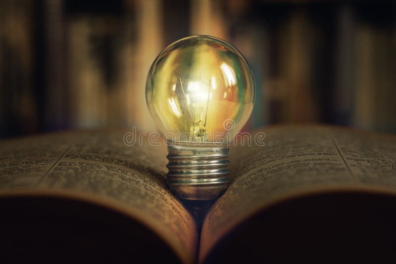 Light Bulb Placed on an Opened Book Stock Image - Image of electric ...