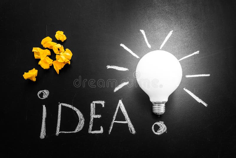 Light Bulb with Rays on the Black Chalkboard with Title Idea! Written ...