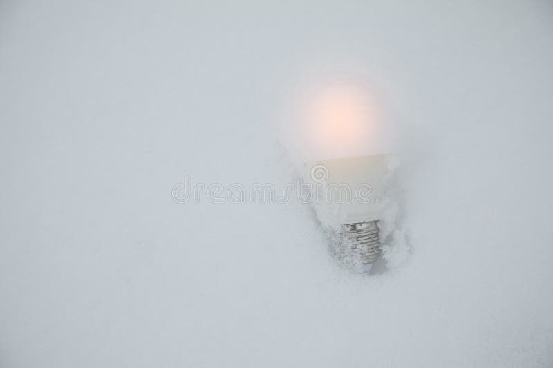 Light Bulb on Snow at Winter Stock Photo - Image of celebration, winter ...