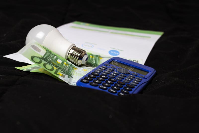 Light Bulb on a Stack of Cash, Symbolizing a Bright Financial Idea ...