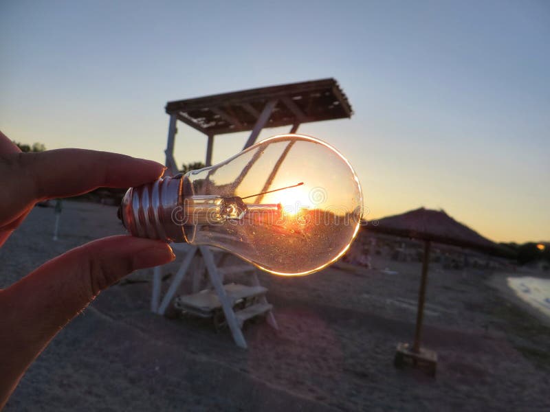 Light Bulb on the Sunset Background with Light Rays Like Electricity ...