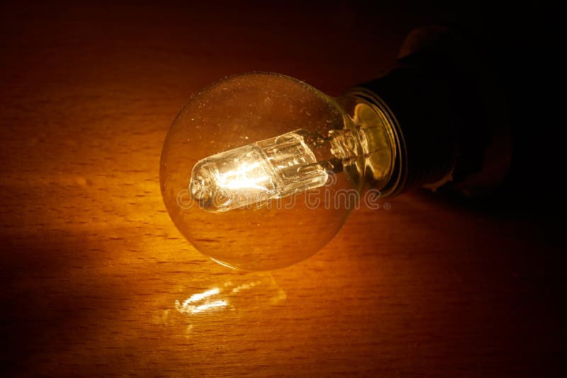Light bulb on a table stock image. Image of electricity - 130678465