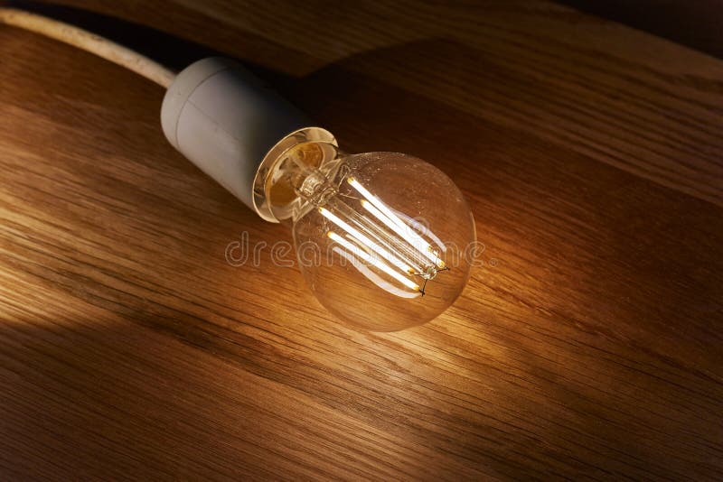 Light bulb on a table stock photo. Image of bulb, blinking - 144300732