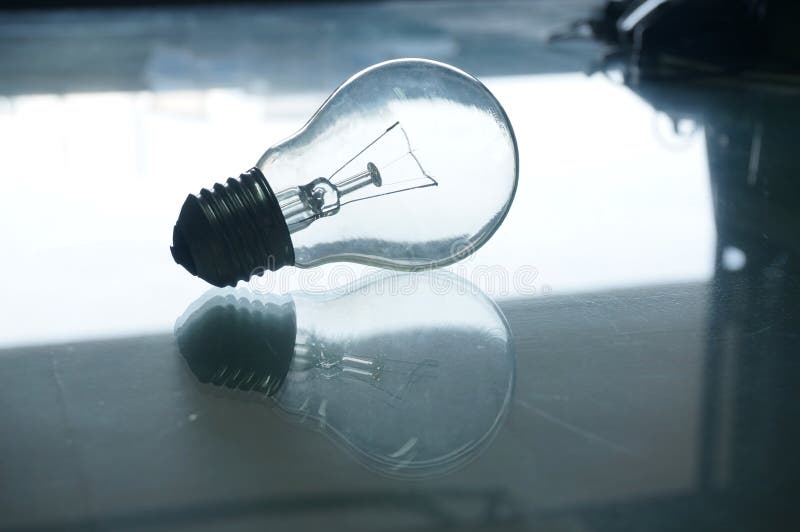 Light Bulb on Table Glass Against Bright Window Stock Image - Image of ...
