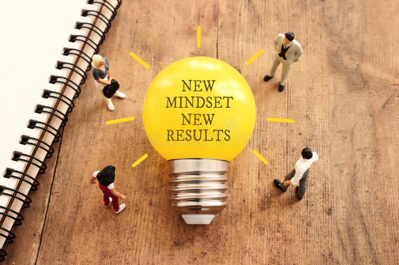 Light Bulb with the Text New Mindset in on Wooden Table Stock Photo ...