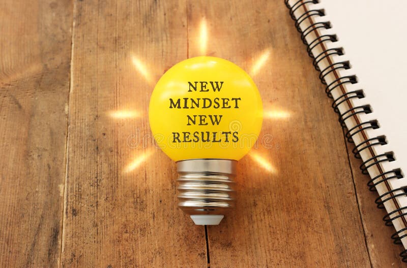 Light Bulb with the Text New Mindset in on Wooden Table Stock Photo ...