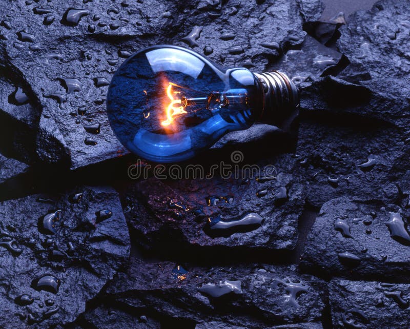 Light bulb on wet rocks stock photo. Image of light, brightly - 5986892