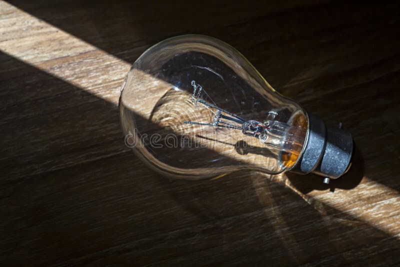Light Bulb on Wood Texture Background, Light and Shadow, Close Up and ...