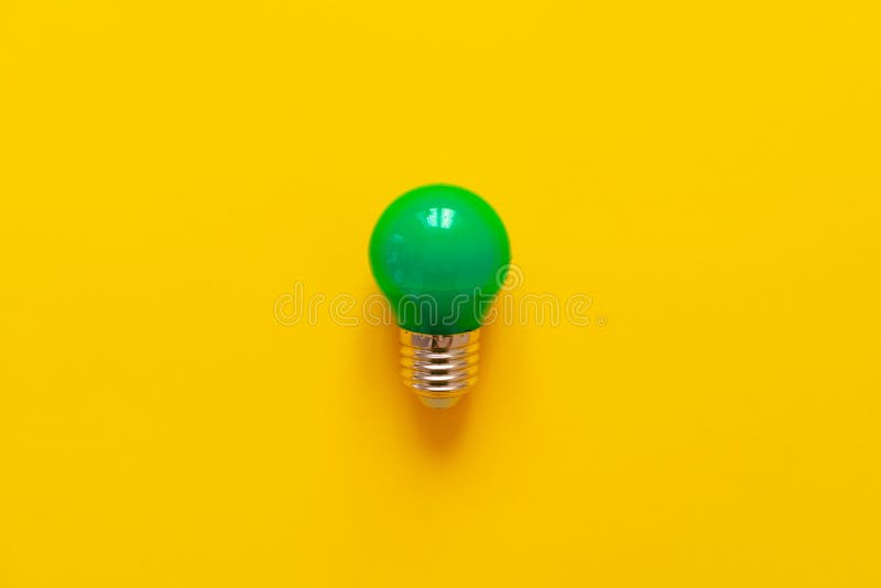 Light Bulb on Yellow Paper Background Top View Stock Photo - Image of ...