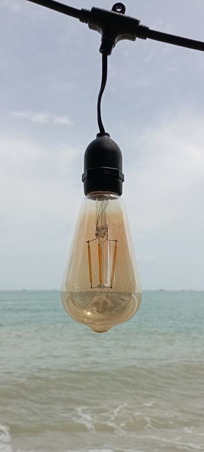 Light bulbs on the beach stock photo. Image of night - 283323792
