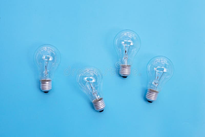 Light Bulbs on Blue Background. Ideas and Creative Thinking Concept ...