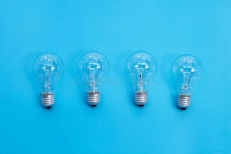 Light Bulbs on Blue Background. Ideas and Creative Thinking Concept ...