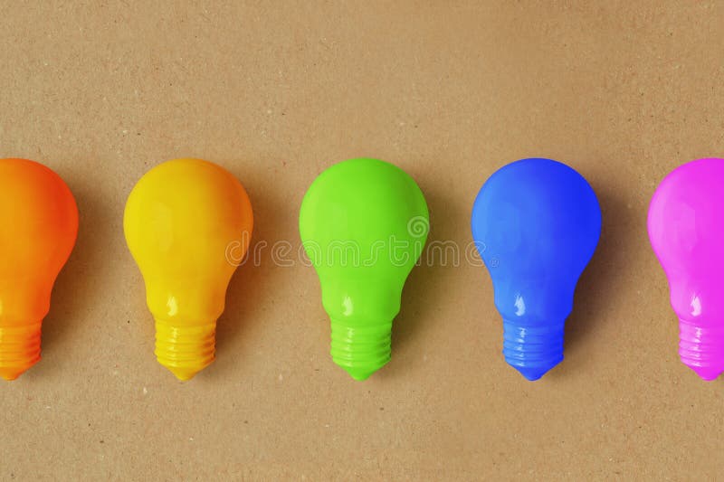 Light Bulbs in Different Colors on Recycled Paper Background - Concept ...