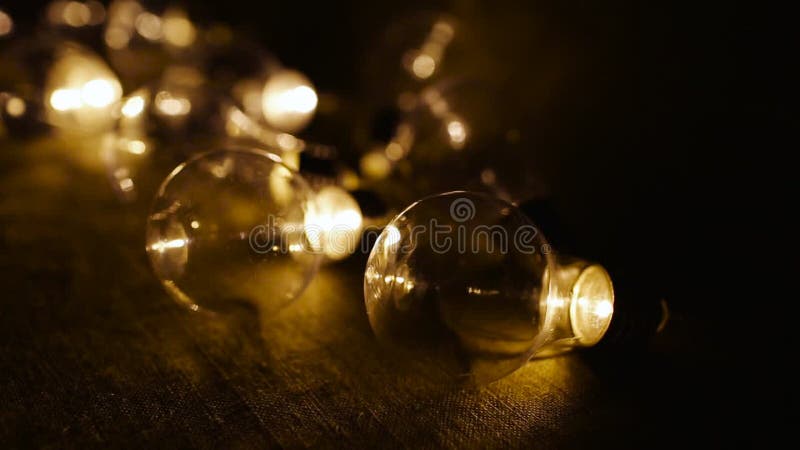 Light Bulbs with Dim Light Lying on a Brown Background. Christmas ...