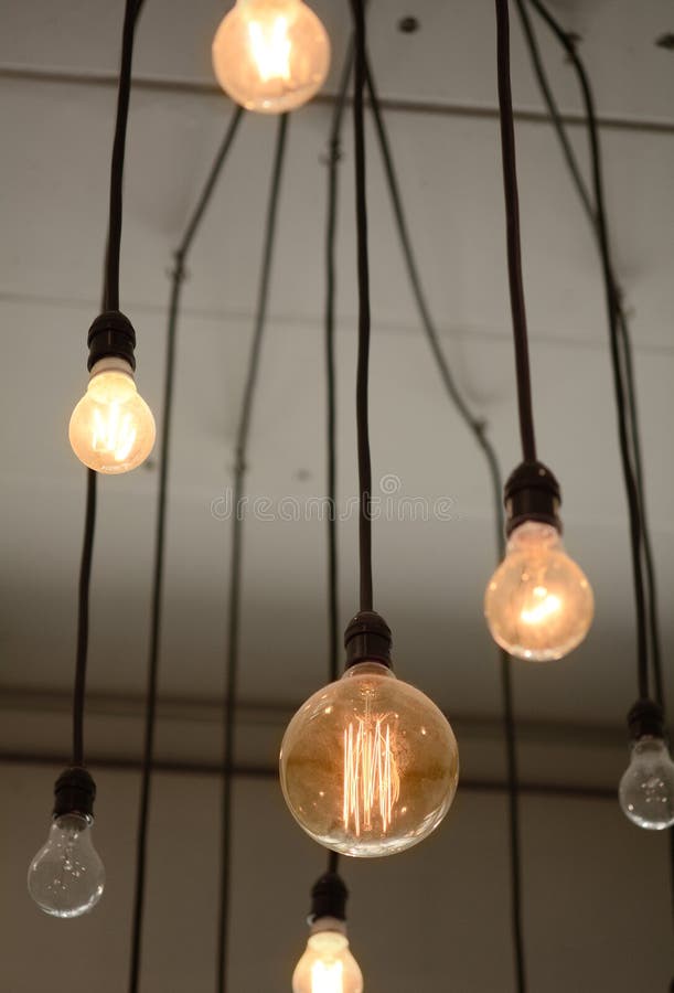 Light Bulbs Hanging on the Ceiling Stock Photo - Image of glow, black ...
