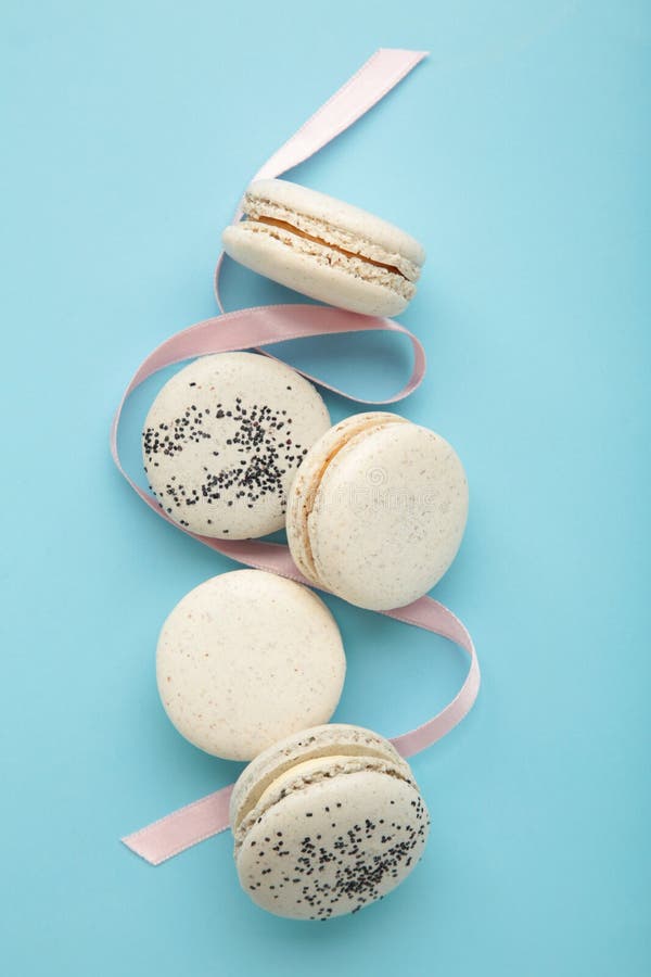 Light Cake Macaron or Macaroon with Ribbon on Blue Background. Sweet ...
