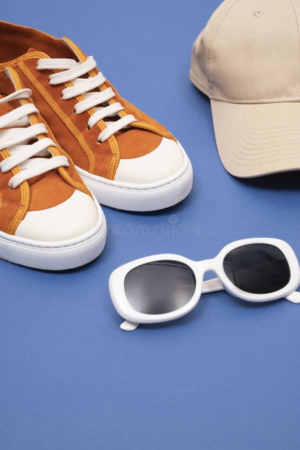 Light Cap with Red Sneakers on a Blue Background Stock Image - Image of ...