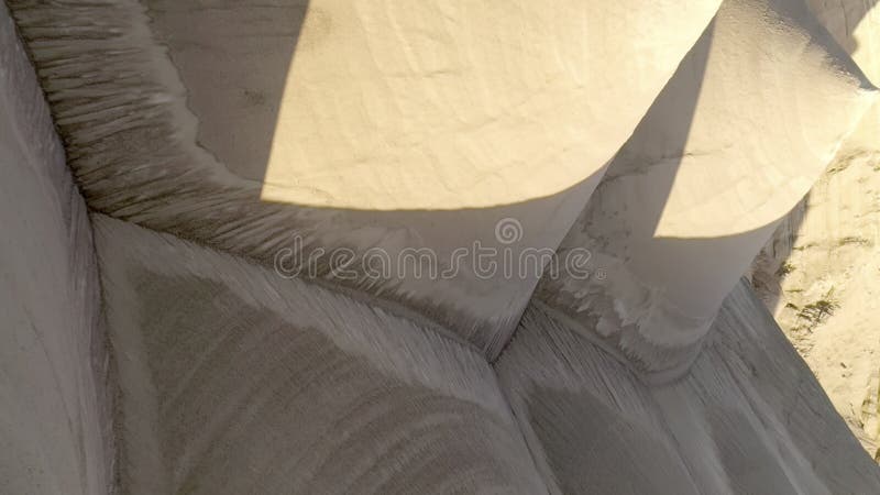 Light-colored Sand Piles in a Mining Area. Evening Sunshine Casts Long ...