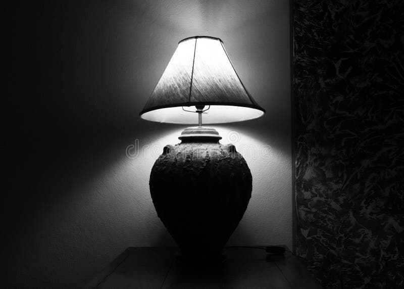 Light in the Dark, Lamp Shining Light on a Wall Black and White Stock ...