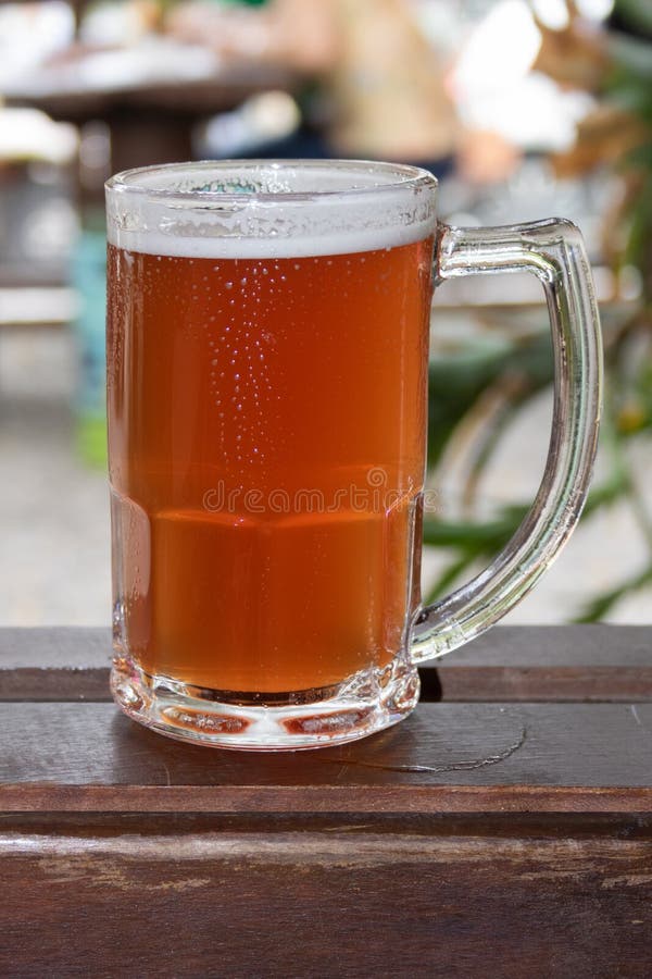 Light draft beer on mug stock photo. Image of hour, glass - 210604508