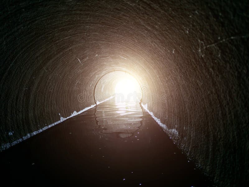 Light at End of Round Flooded Sewer Tunnel. Exit from Sewer System ...