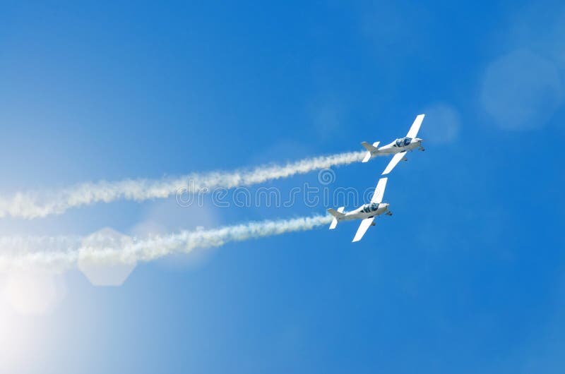 Light Engine Airplane with a Trace of White Smoke Fly in Groups in the ...