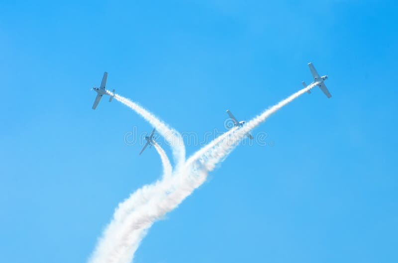 Light Engine Airplane with a Trace of White Smoke Fly in Groups in the ...