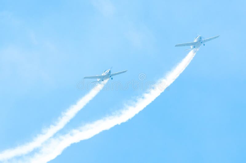 Light Engine Airplane with a Trace of White Smoke Fly in Groups in the ...