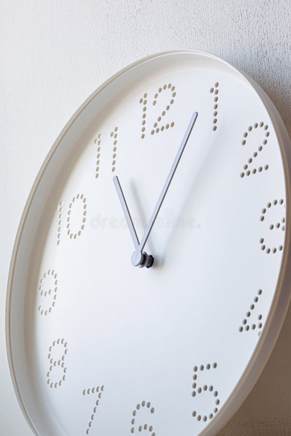 Light Falls on White Wall Clock with Perforated Numbers Stock Photo ...