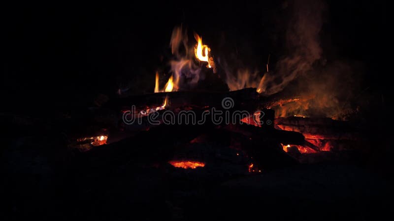 The Light from the Fire and the Flames in the Night Sky. the Colors of ...