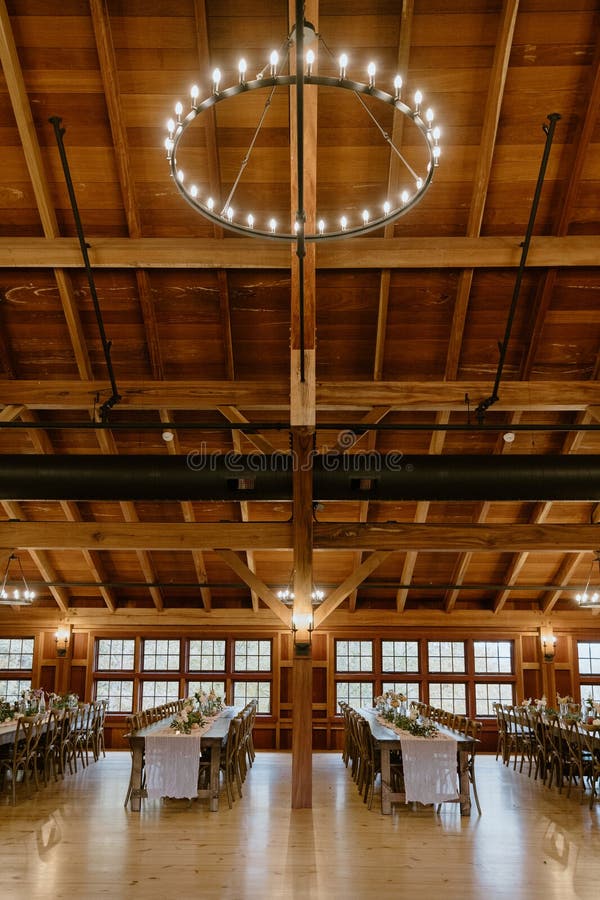 Light Fixture Hanging from Rafter Ceiling in Rustic Barn Reception Hall ...