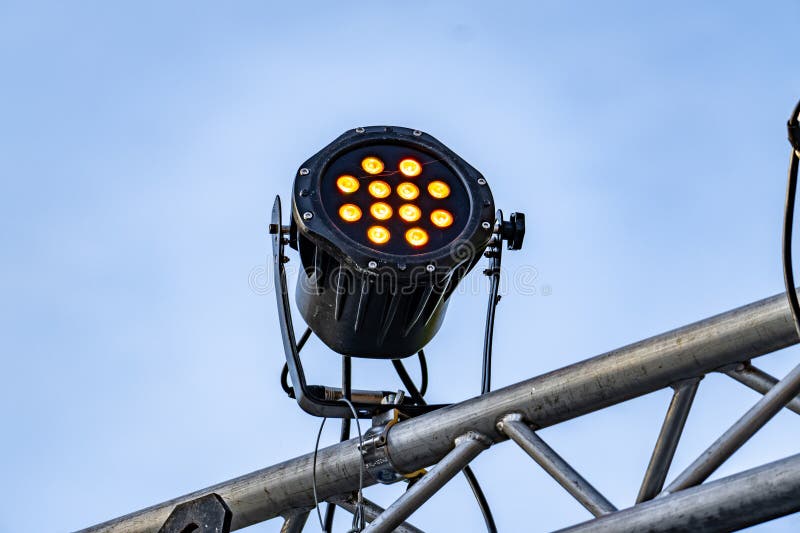 A Light Fixture with a Yellow Light is Hanging from a Metal Structure ...
